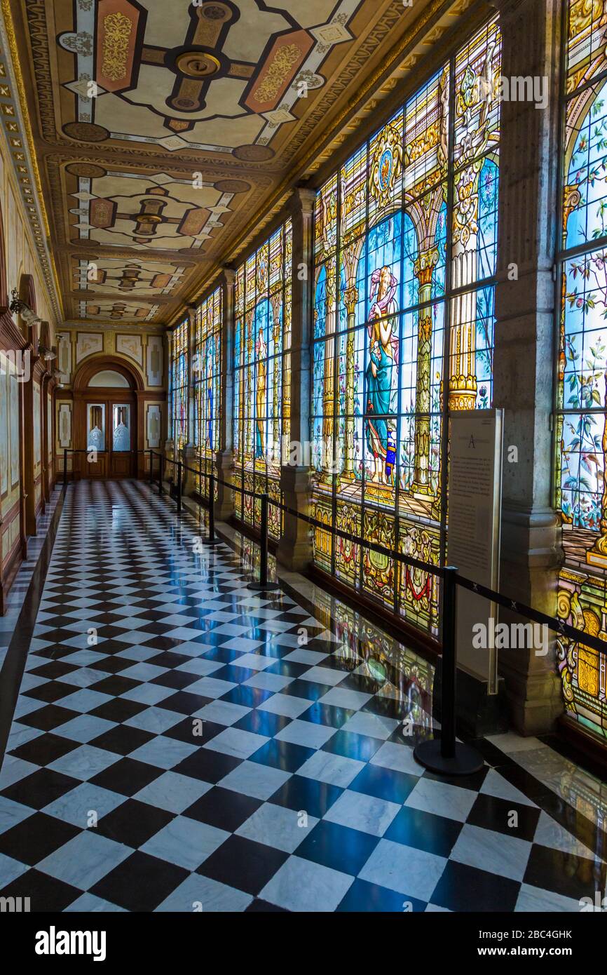 Hallway lined with ornate stain glass murals, at Chapultepec Castle, in ...