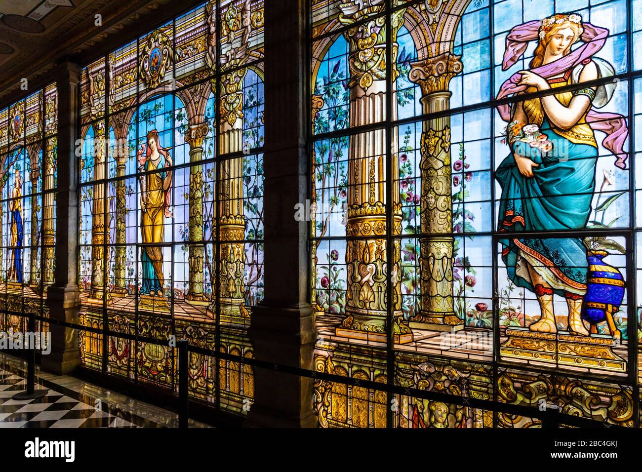 Hallway lined with ornate stain glass murals, at Chapultepec Castle, in ...