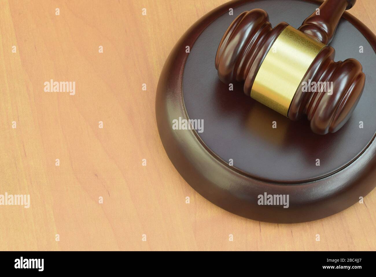 Justice mallet on wooden desk in a courtroom during a judicial trial. Law concept and empty copy ...