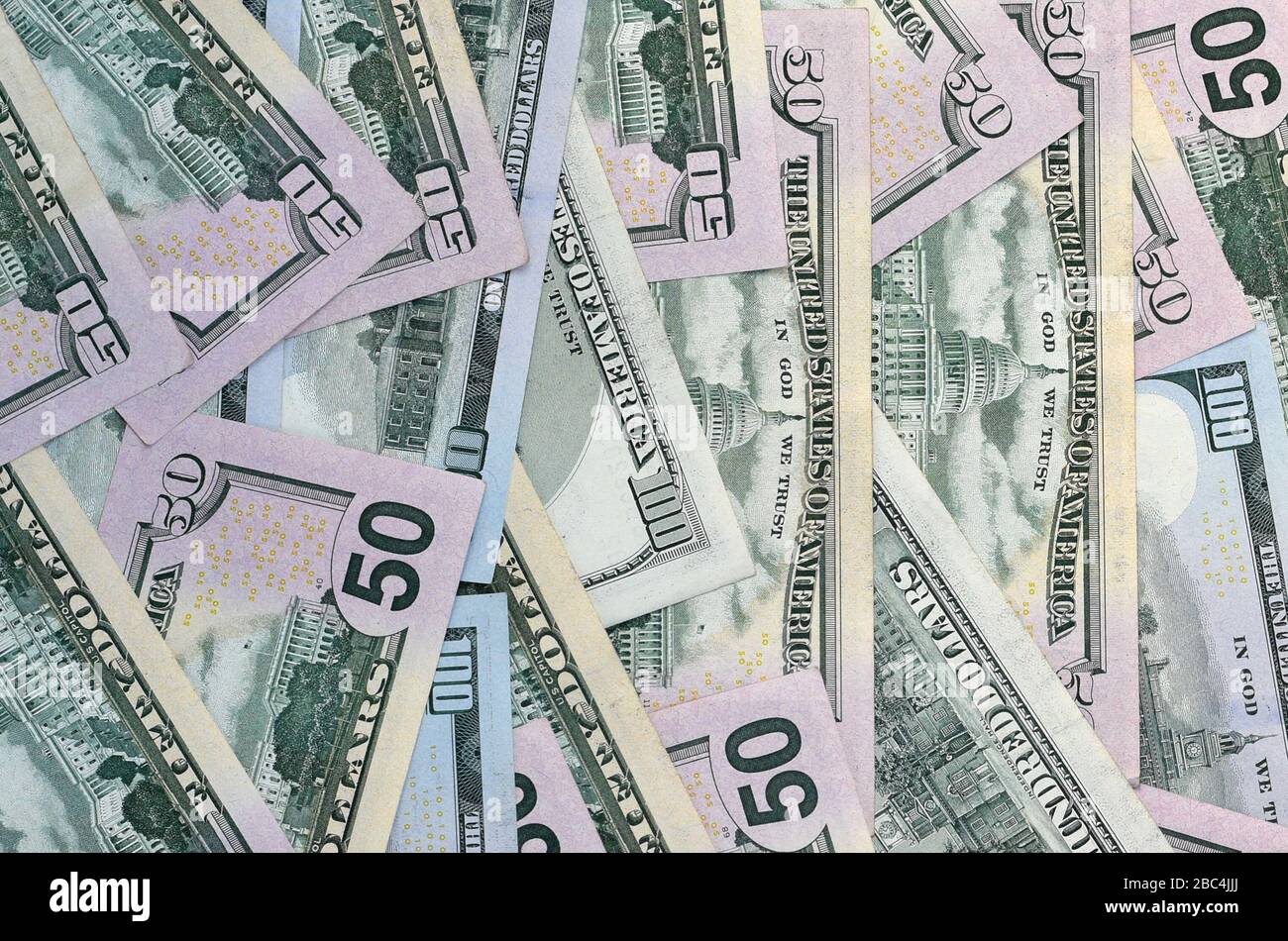 Many one hundred and fifty dollar bills on flat background surface ...