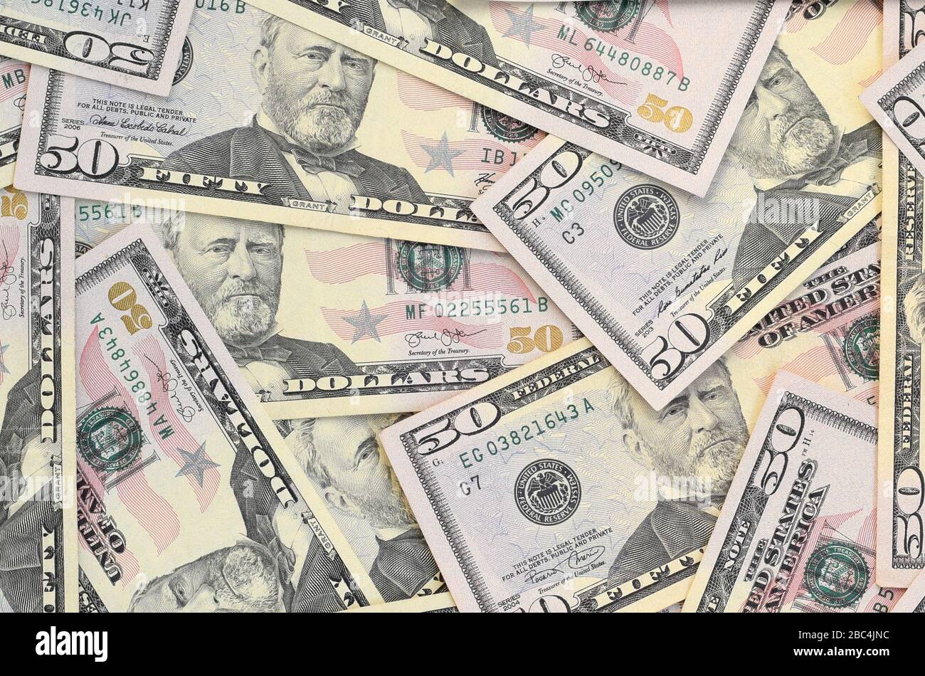 Many US fifty dollar bills on flat background surface close up. Flat ...