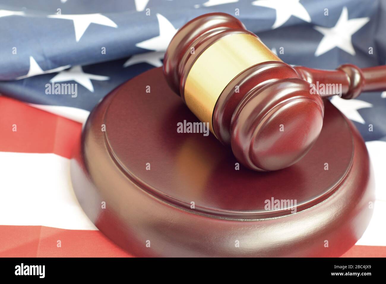 Justice mallet on United States flag in a courtroom during a judicial ...