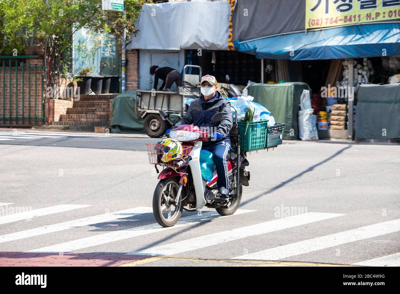Motorcycle delivery wearing a mask during the Coronavirus pandemic ...
