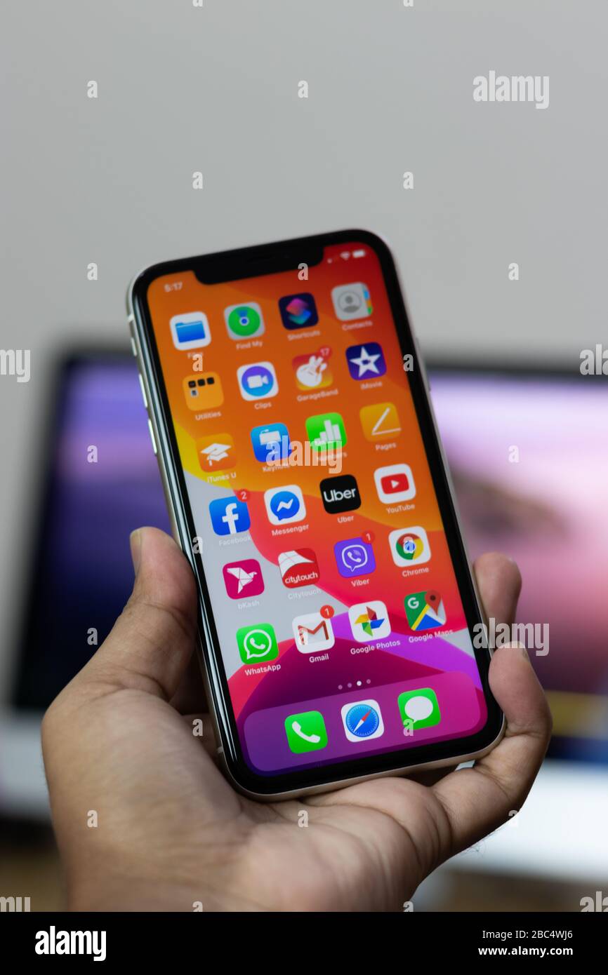 Backside of iPhone 11 white variant holding on hand Stock Photo - Alamy