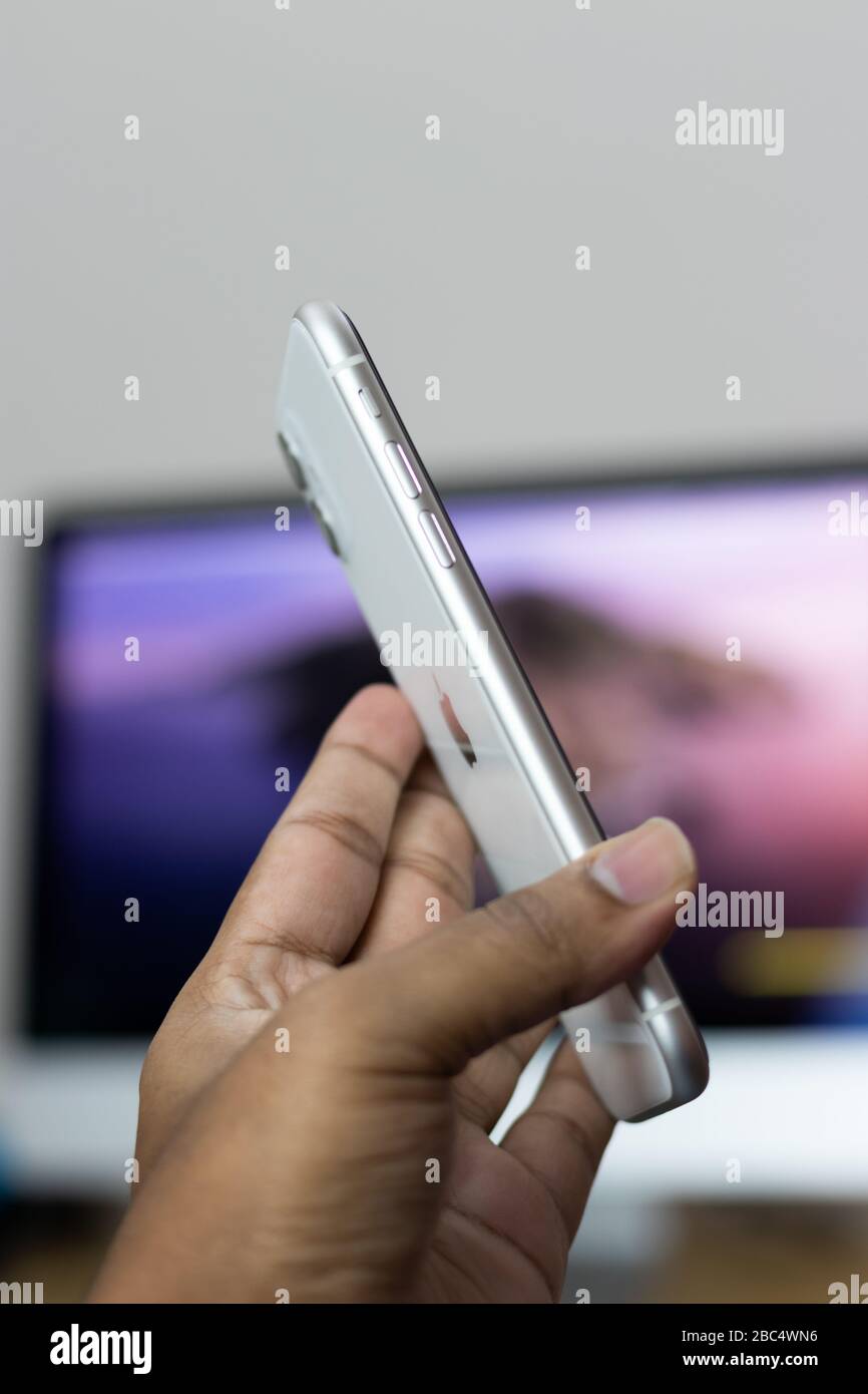 Backside of iPhone 11 white variant holding on hand Stock Photo - Alamy
