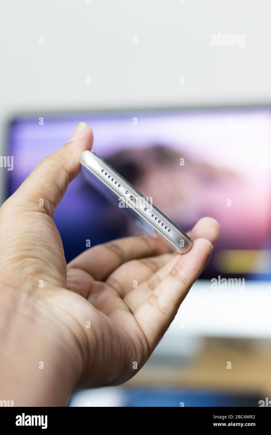 Backside of iPhone 11 white variant holding on hand Stock Photo - Alamy