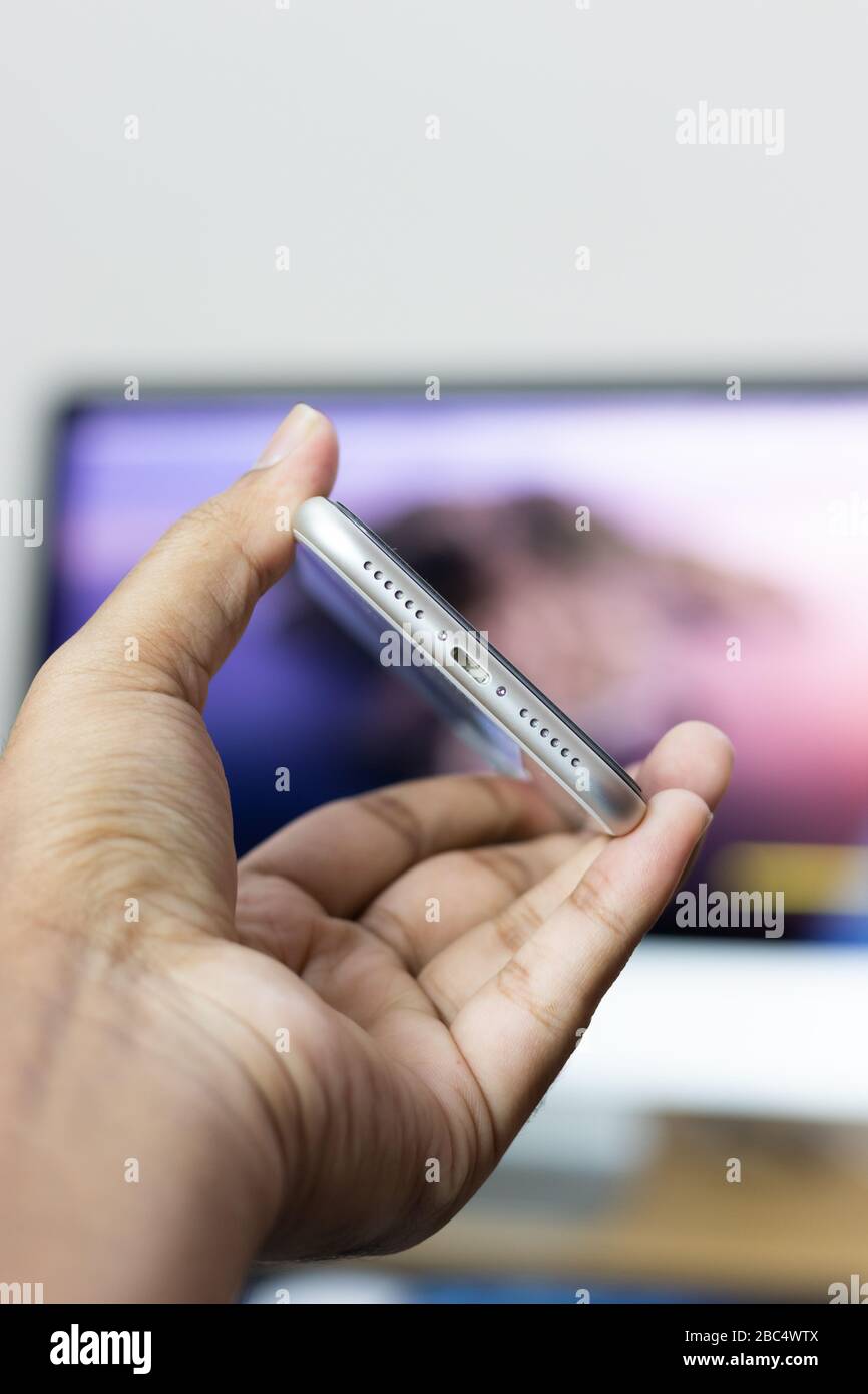 Backside of iPhone 11 white variant holding on hand Stock Photo - Alamy