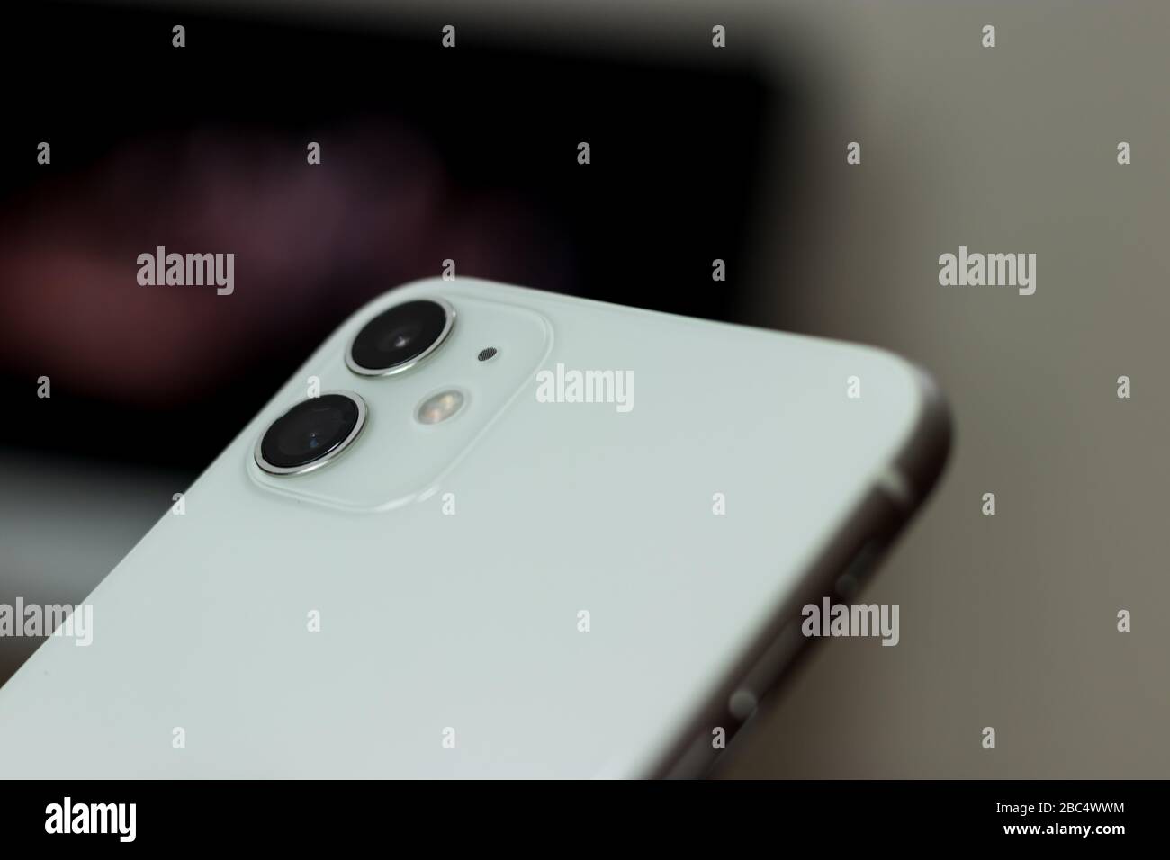 Backside of iPhone 11 white variant holding on hand Stock Photo - Alamy