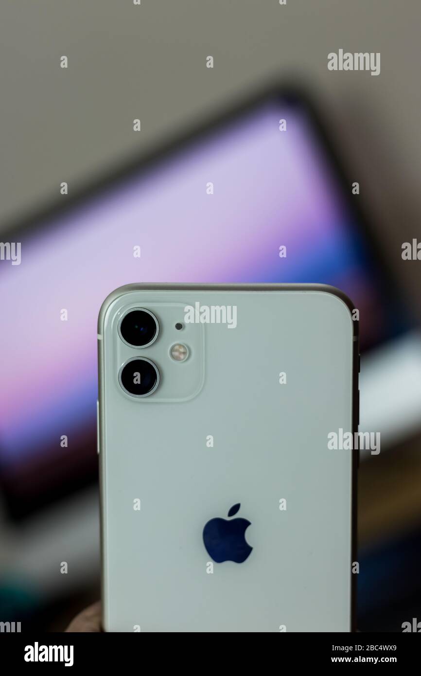 Backside of iPhone 11 white variant holding on hand Stock Photo - Alamy