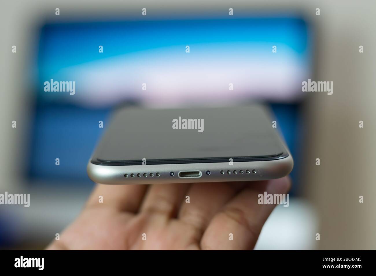 Backside of iPhone 11 white variant holding on hand Stock Photo - Alamy