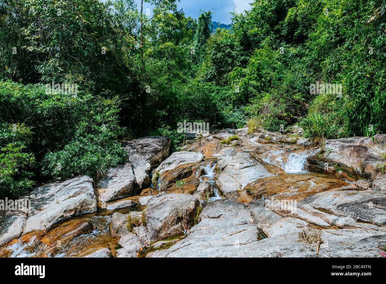 A small mountain river flows among large stones in mountainous areas ...