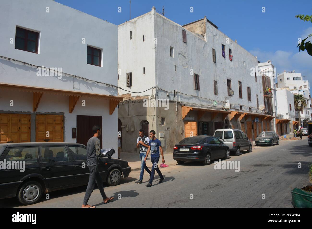Locals walk in the street on the edge of the historic medina (Ancienne ...