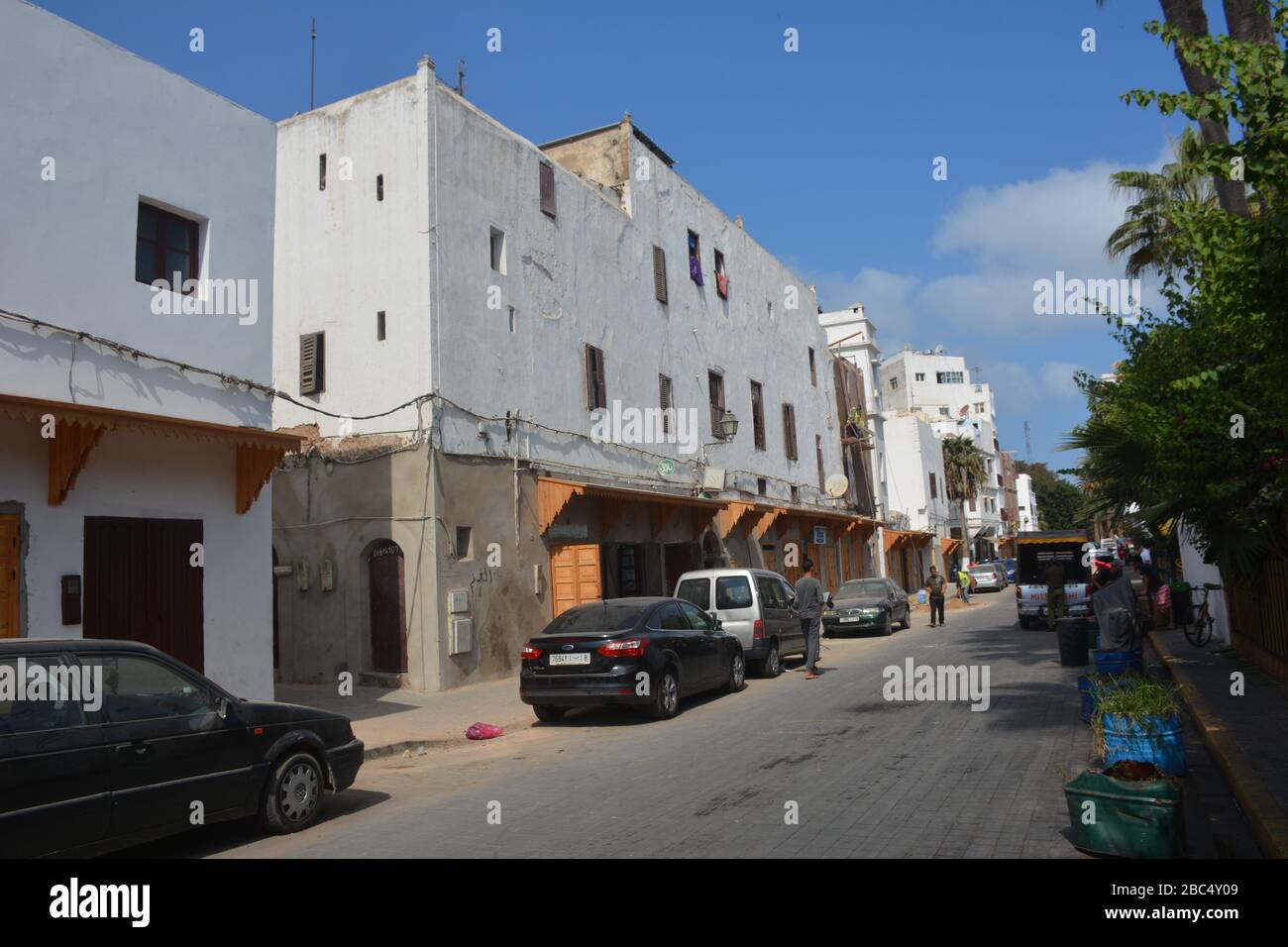 Locals walk in the street on the edge of the historic medina (Ancienne ...