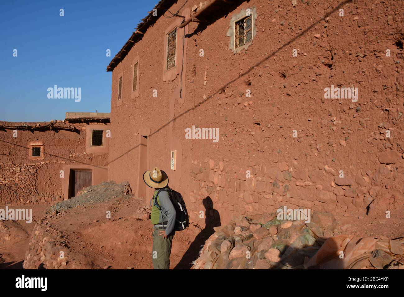 A local Moroccan tour guide stands in afternoon light in an Amazigh ...