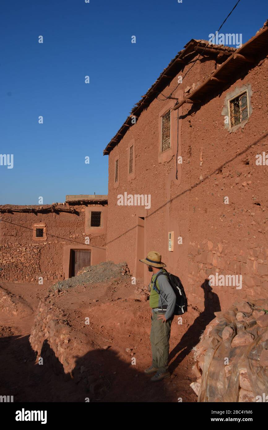A local Moroccan tour guide stands in afternoon light in an Amazigh ...