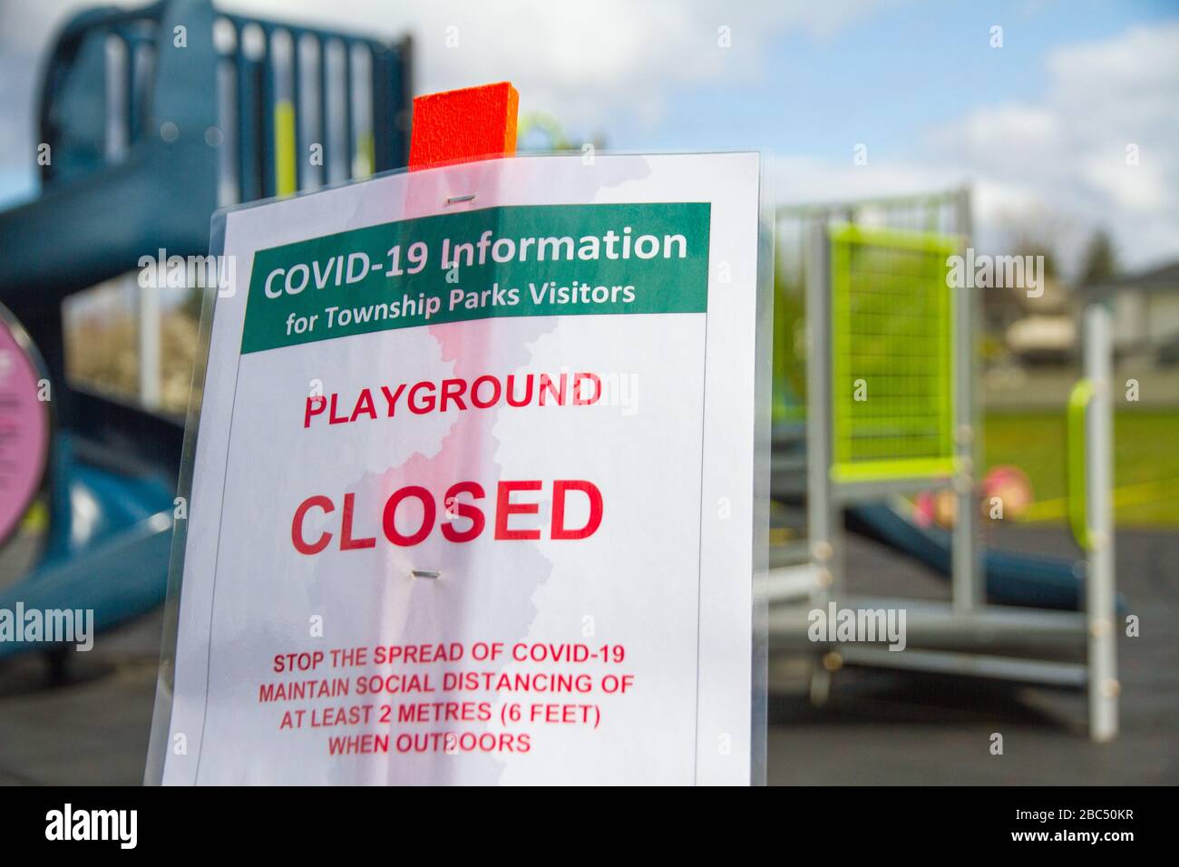 A closed playground sign for COVID-19 infront of a little kids ...