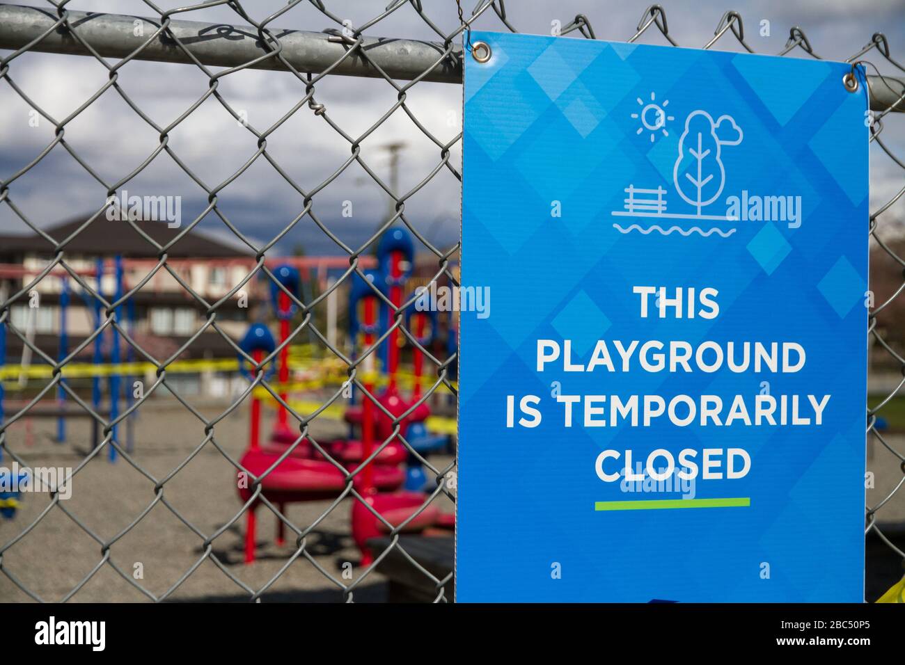 This Playground Is Temporarily Closed Sign with playground taped off in ...
