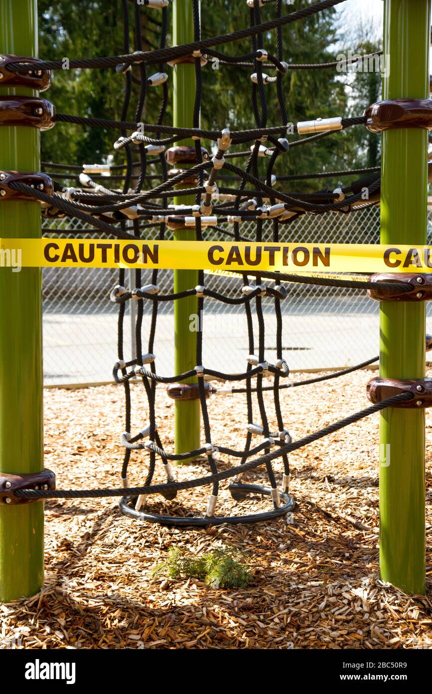Climbing rope structure at a playground is caution taped off due to ...