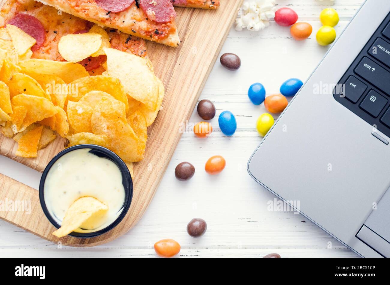 Working at home and snacks. Home office with unhealthy lifestyle ...