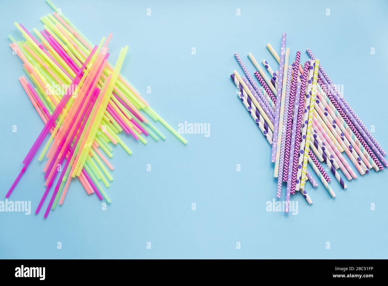Plastic vs paper drinking straws on a blue background. Zero waste ...