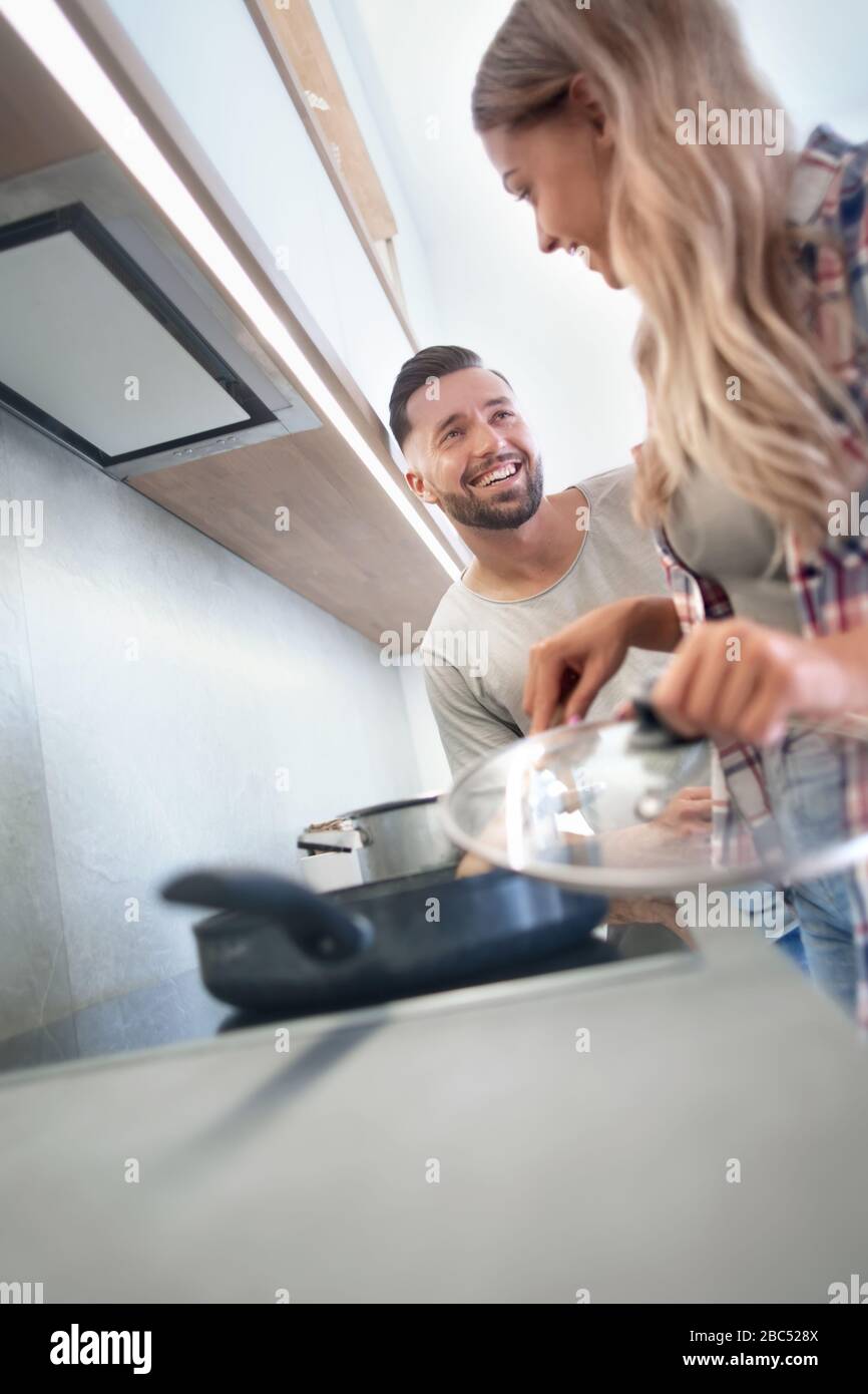 young husband and wife cook dinner together Stock Photo - Alamy