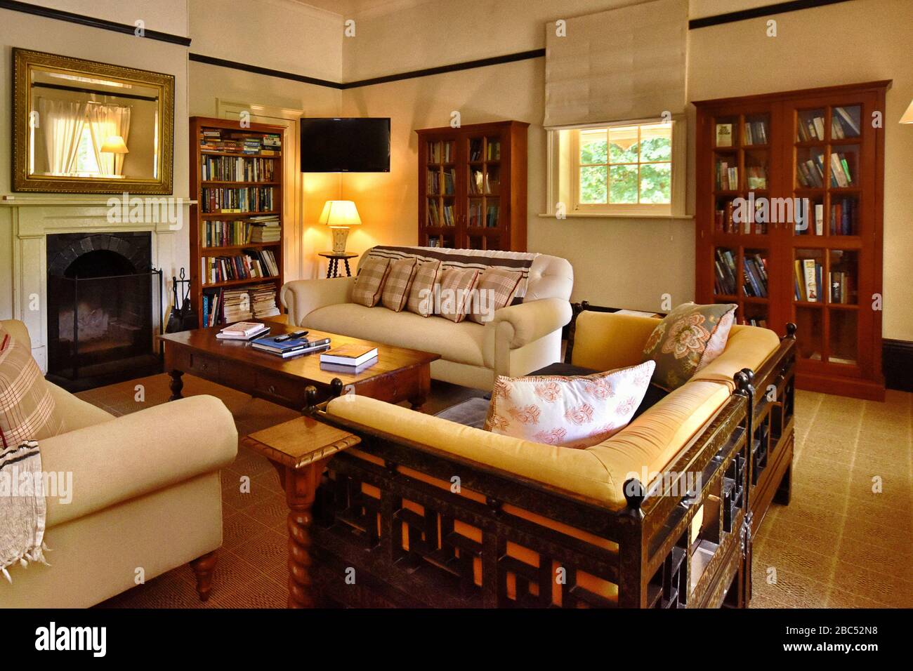 Library & sitting room chinese lacquer couch, fireplace, book shelves ...