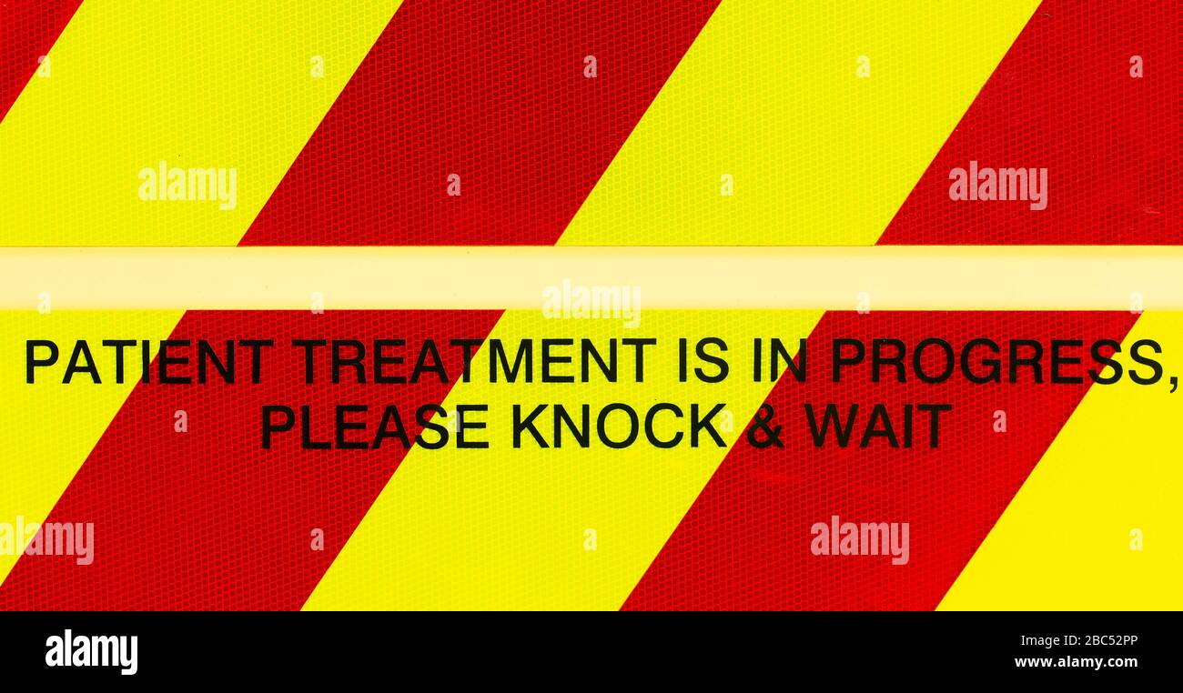 Close up of sign on the back doors of an ambulance reading PATIENT ...