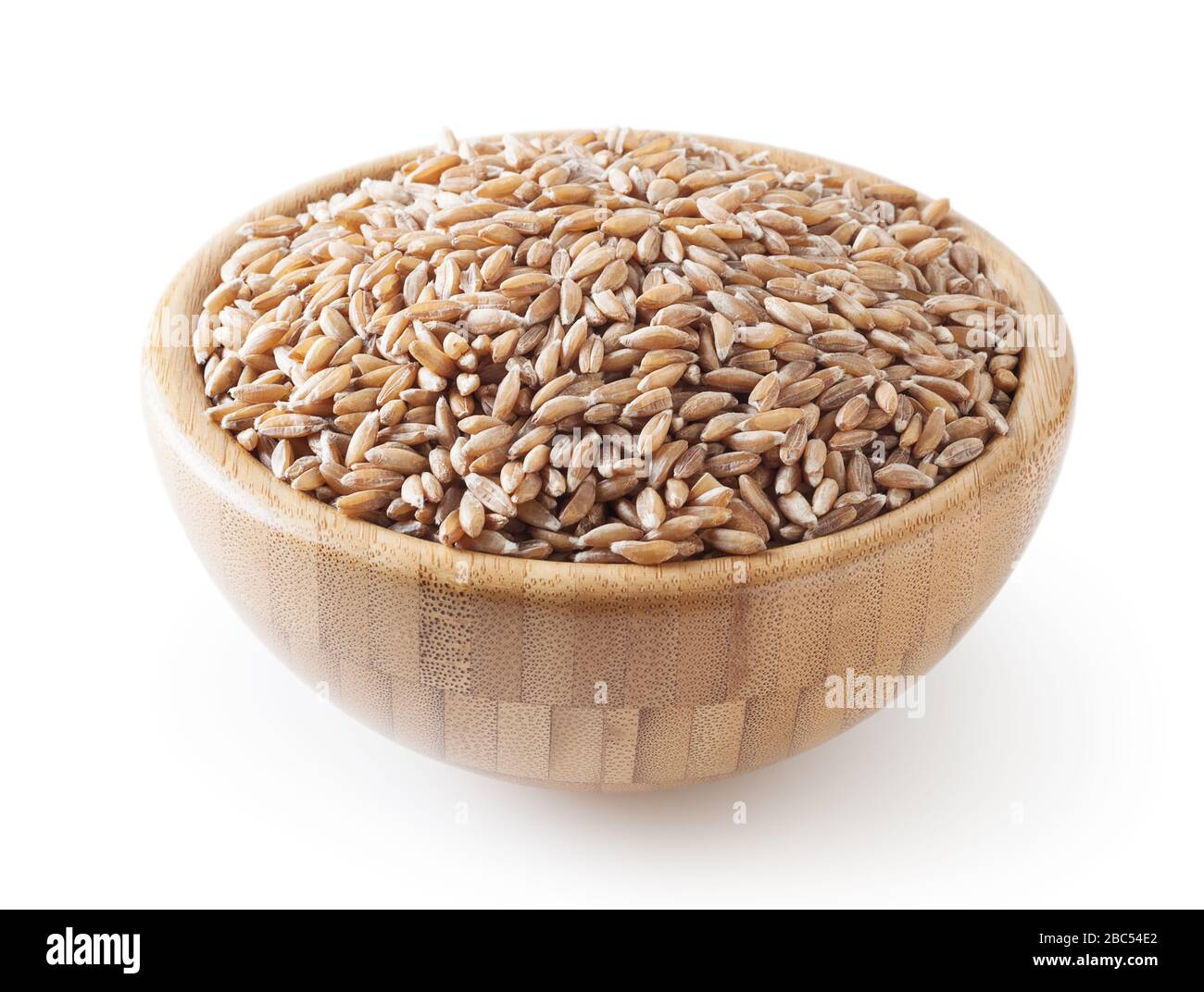 Grains of spelt in wooden bowl isolated on white background wiht ...