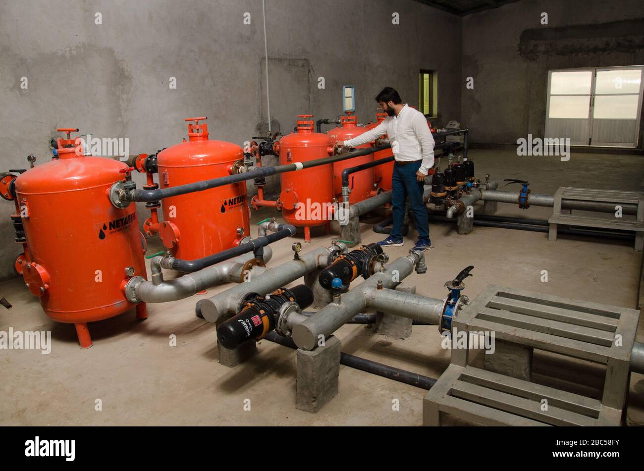 An engineer operates the drip irrigation plant at MA Agri Farm in ...