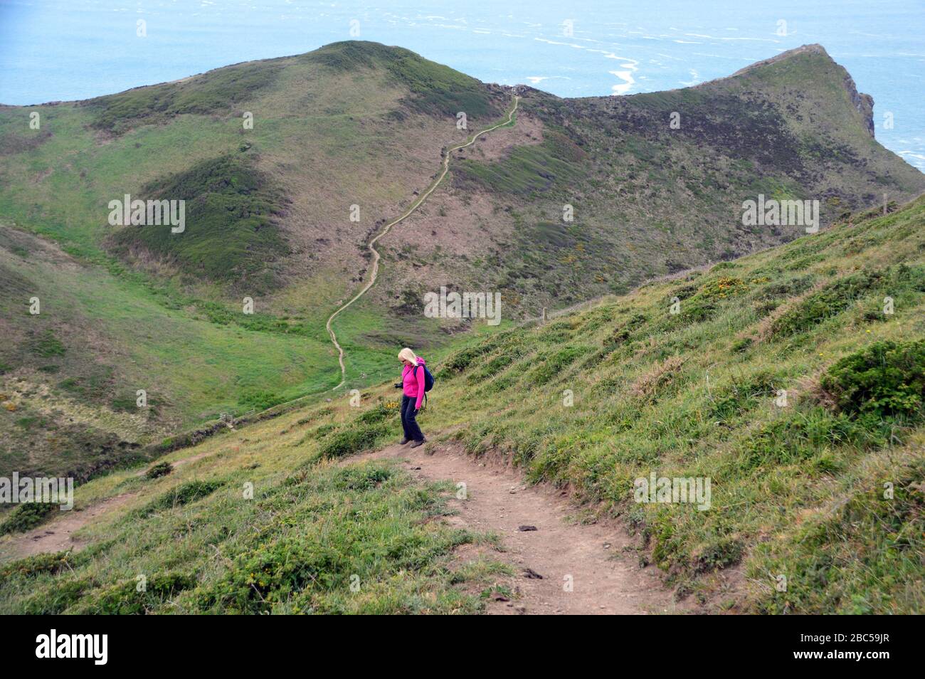 Lone Woman Hiker Walking down to the Tidna Shute Valley with Higher ...
