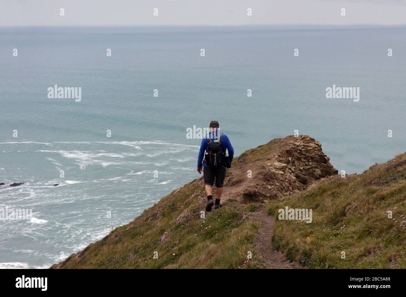 Lone Man Hiker Walking on the Cliff Edge at Steeple Point above ...