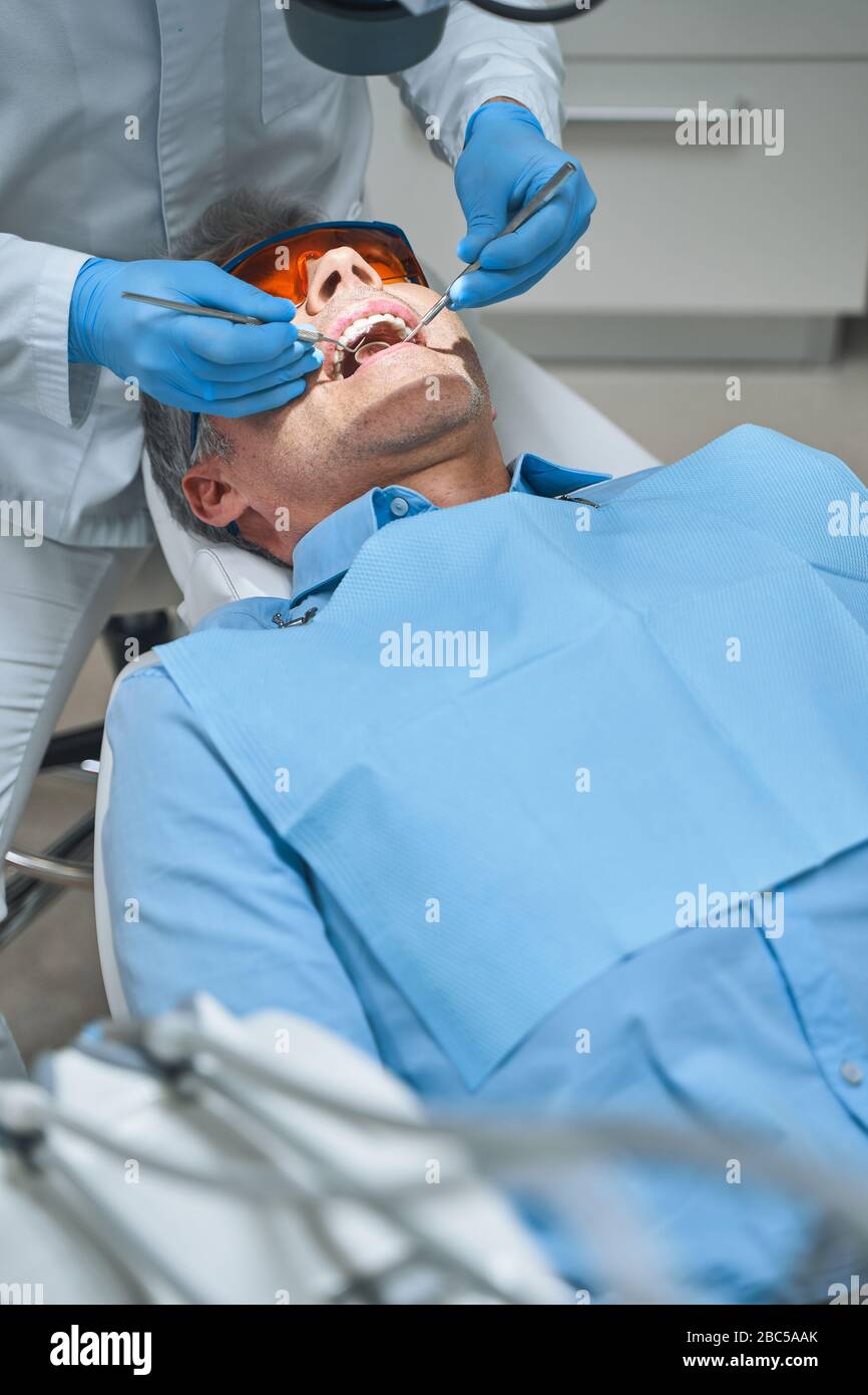 Man during teeth check up stock photo Stock Photo - Alamy