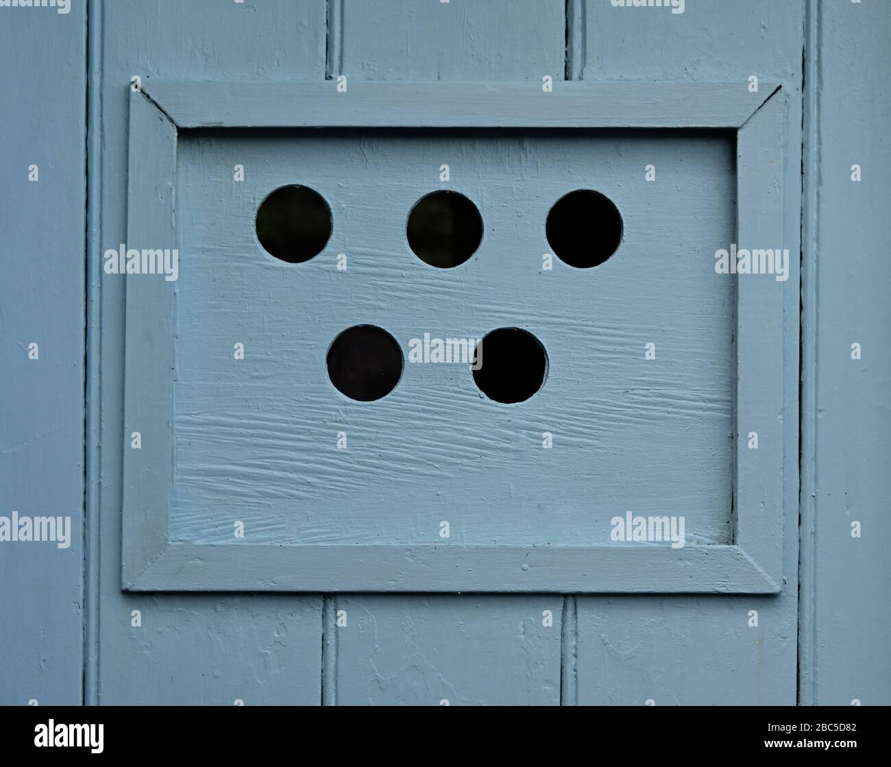 Five round holes in old wooden gate. Fellside, Kendal, Cumbria, England ...