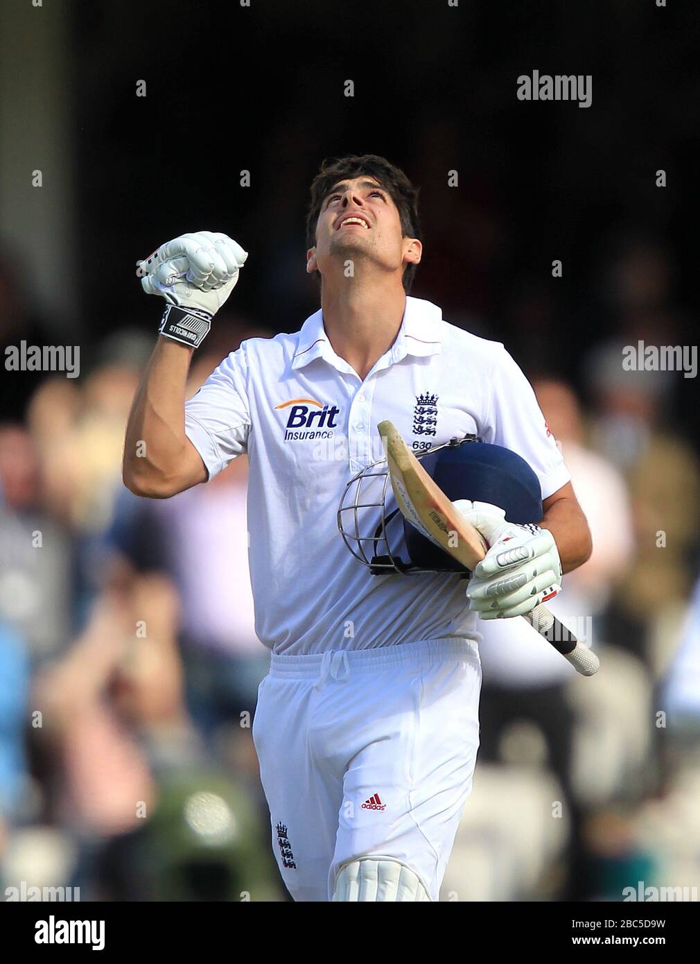 England's Alastair Cook looks to the sky as he celebrates scoring a ...
