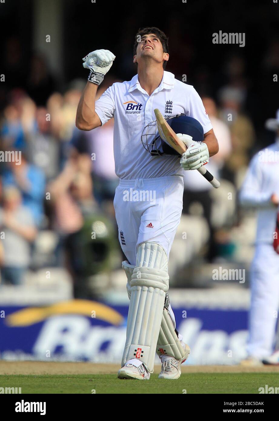 England's Alastair Cook looks to the sky as he celebrates scoring a ...