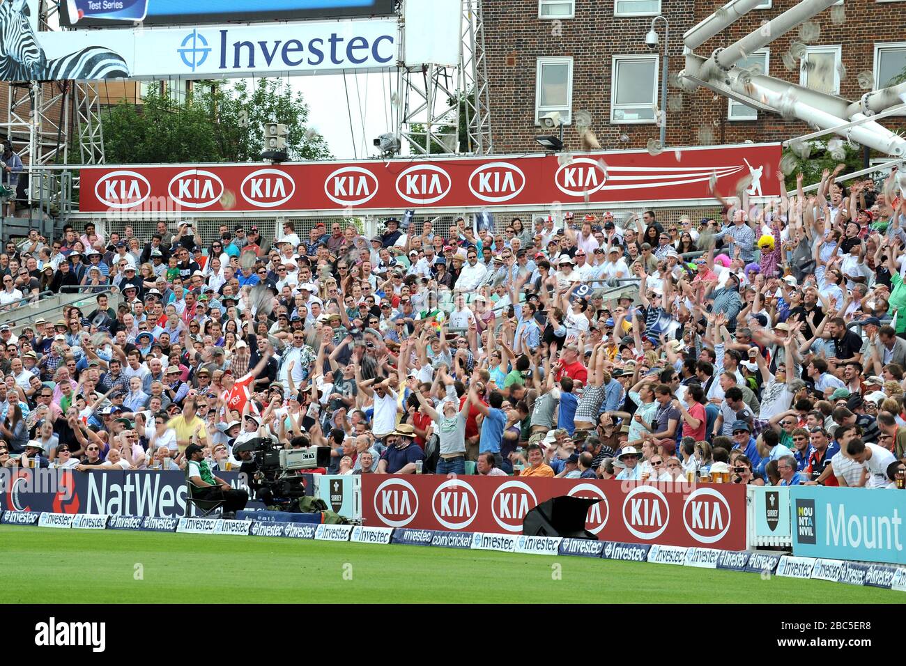 Fans enjoy a Mexican wave in the stands Stock Photo - Alamy