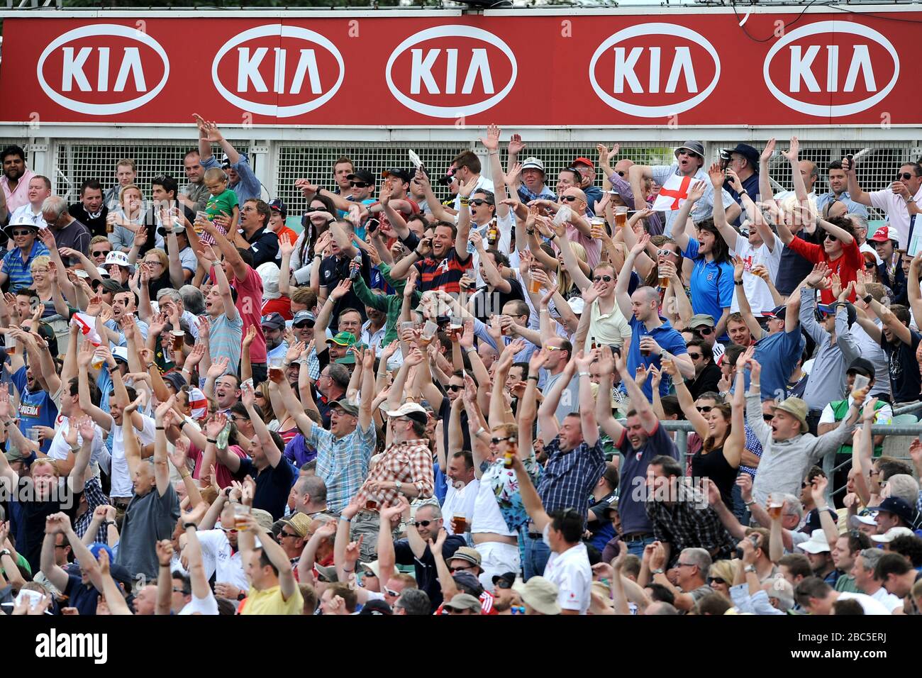 Fans enjoy a Mexican wave in the stands Stock Photo - Alamy