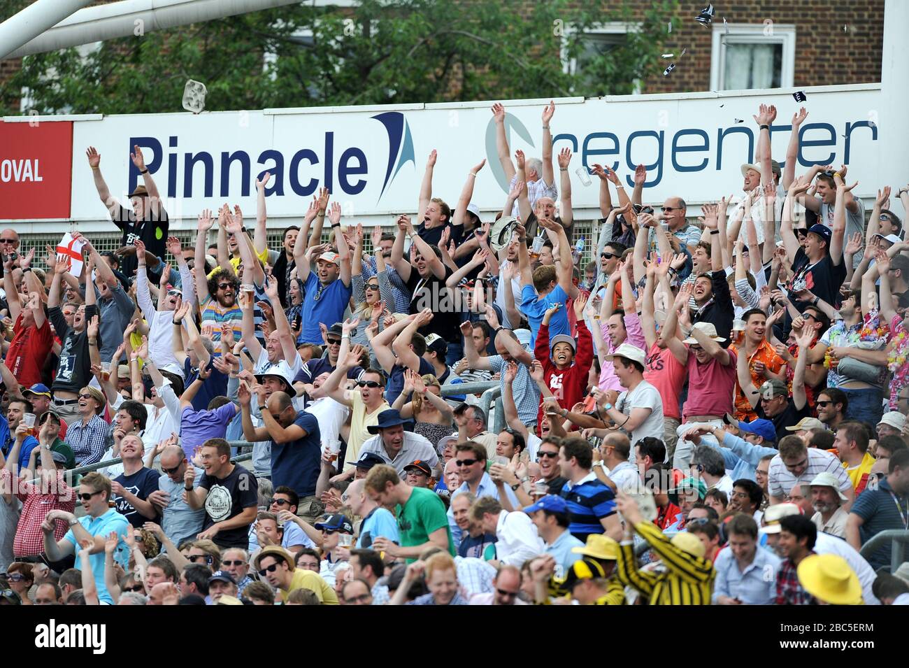 Fans enjoy a Mexican wave in the stands Stock Photo - Alamy