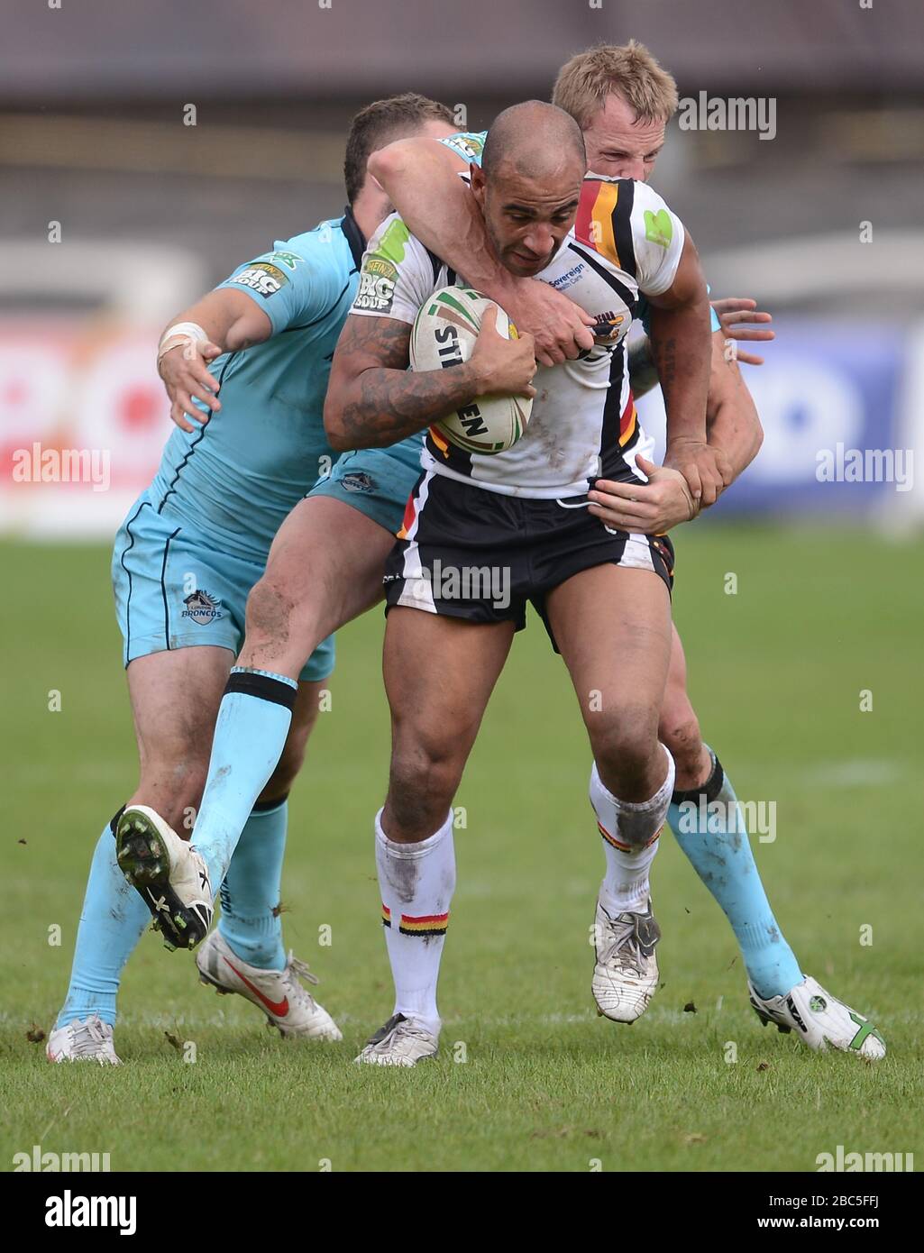 Bradford Bulls' Chev Walker is tackled by London Broncos' David Howell ...