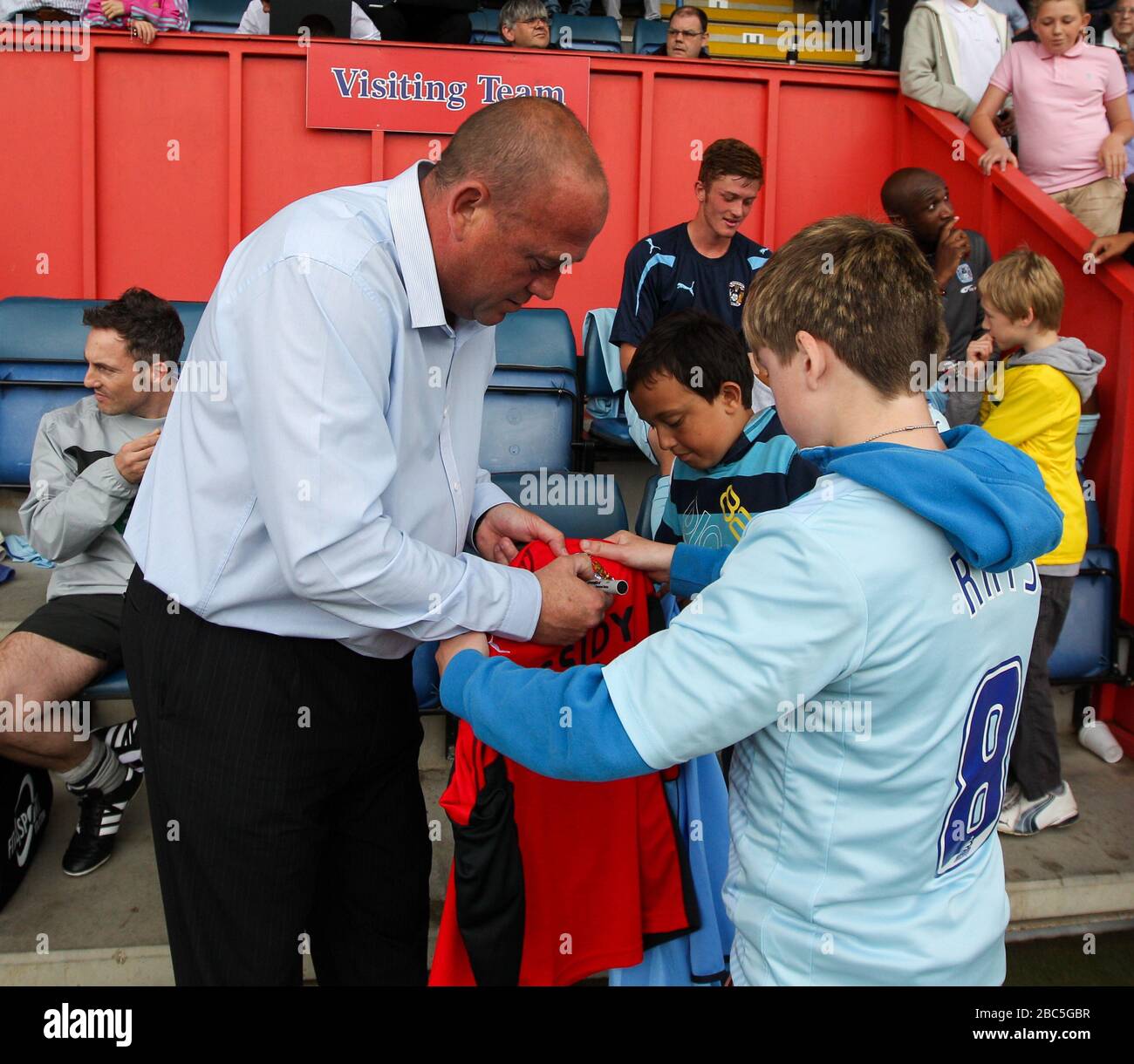 Coventry City's Andy Thorn signs a shirt for fans at half time Stock ...