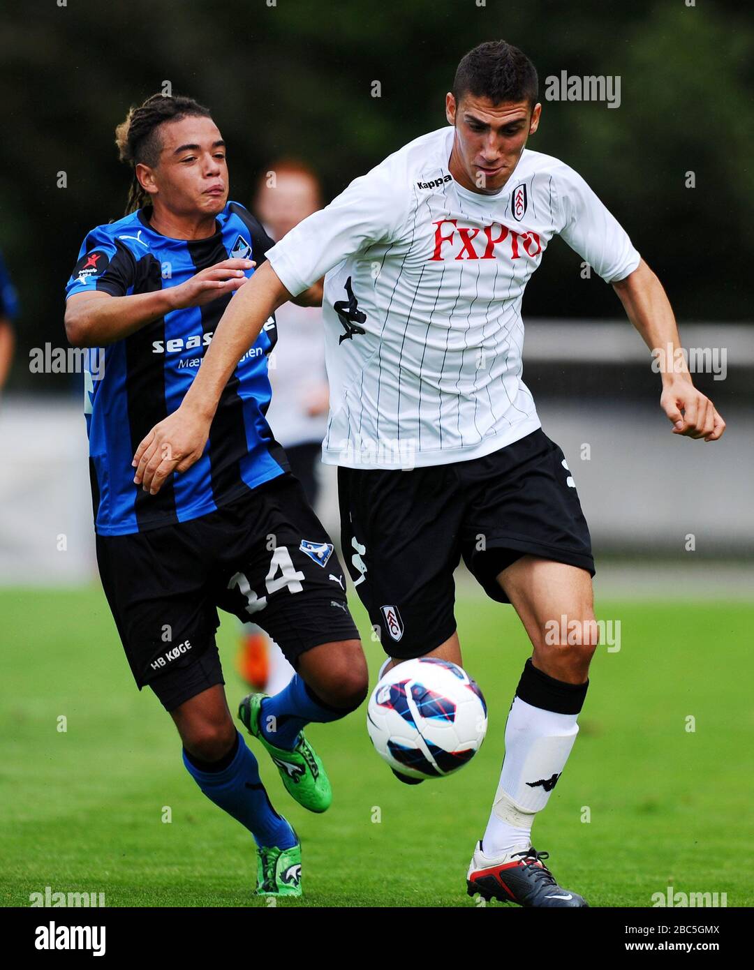 Matthew Briggs, Fulhamand Lee Rochester of HB Koge vie for the ball ...