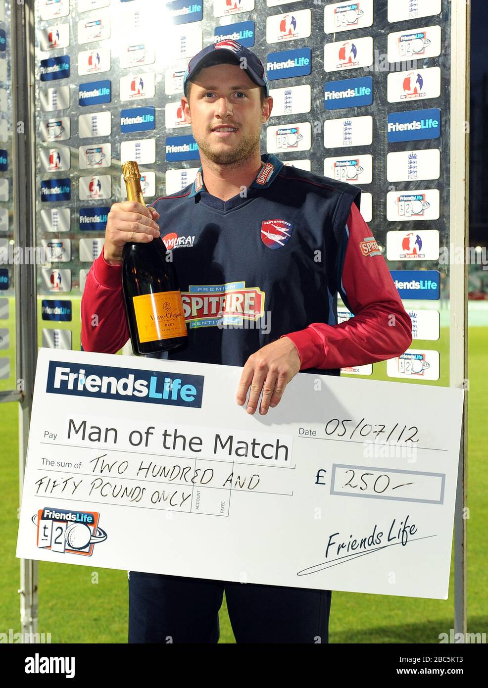 Kent Spitfires' Alex Blake poses for a photo with a bottle of champagne ...