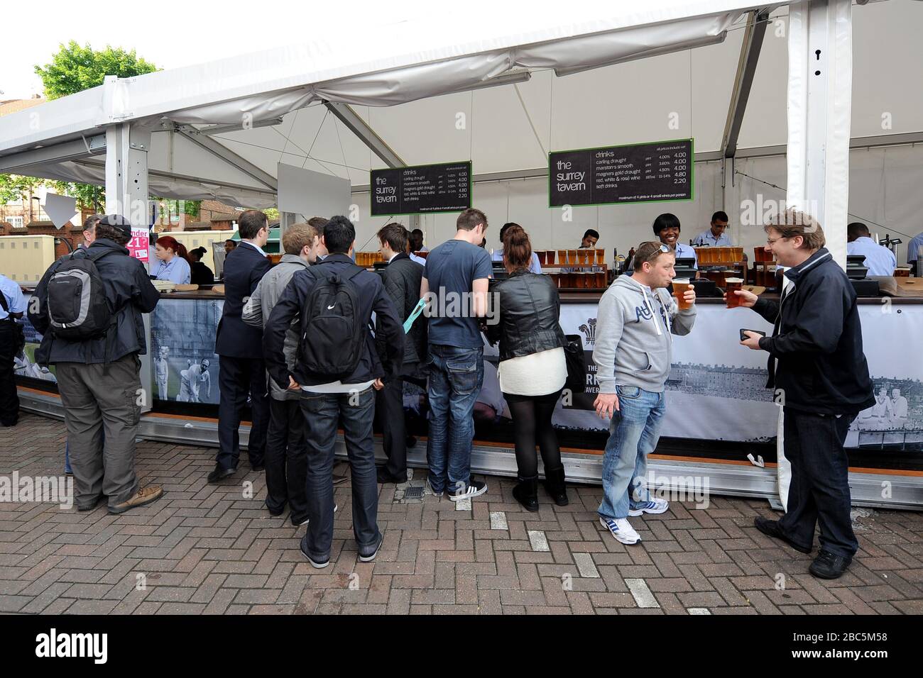 Fans purchase refreshments outside the ground before the game Stock ...