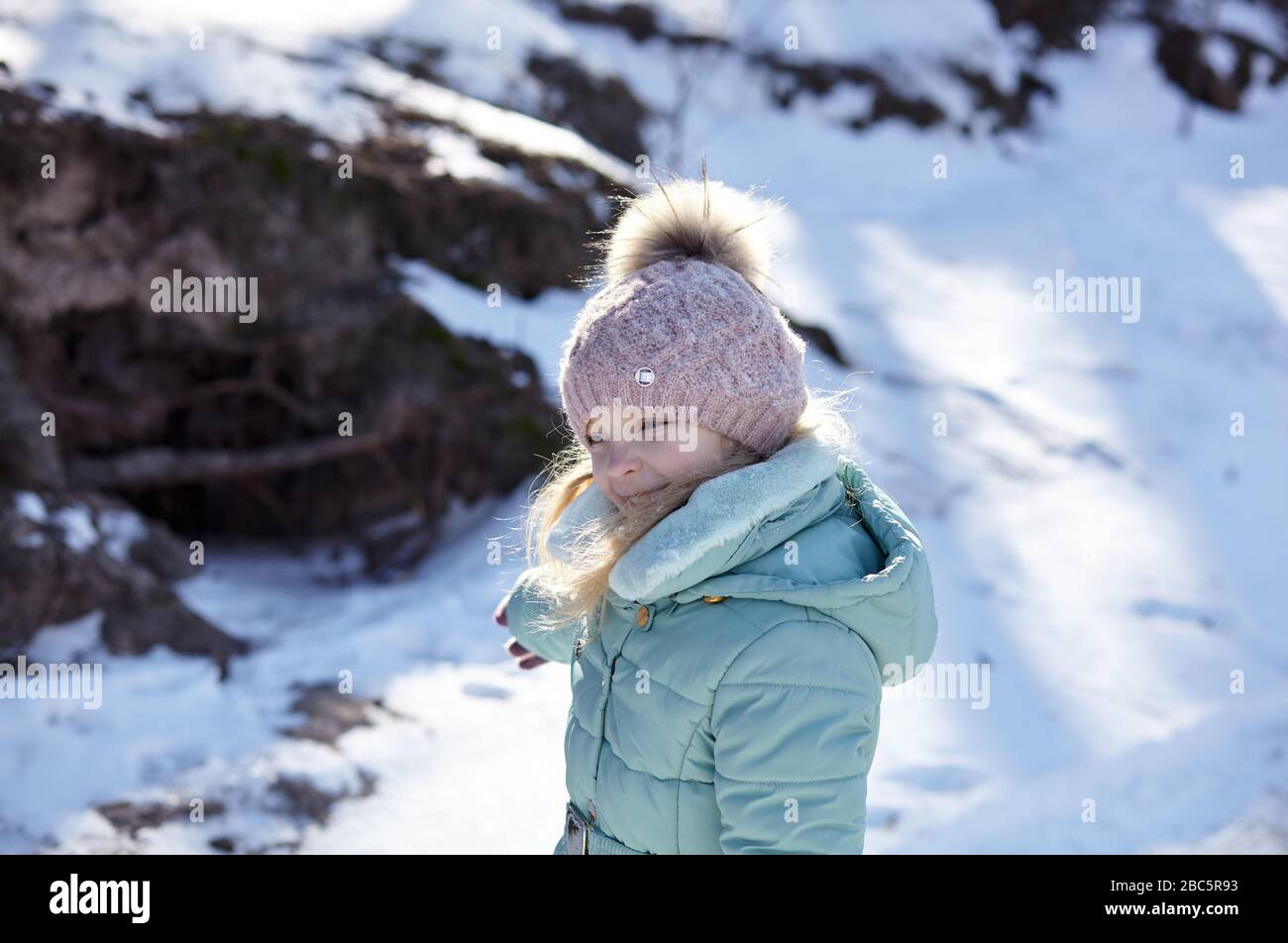 Little kid girl in colorful clothes playing outdoors. Active leisure ...