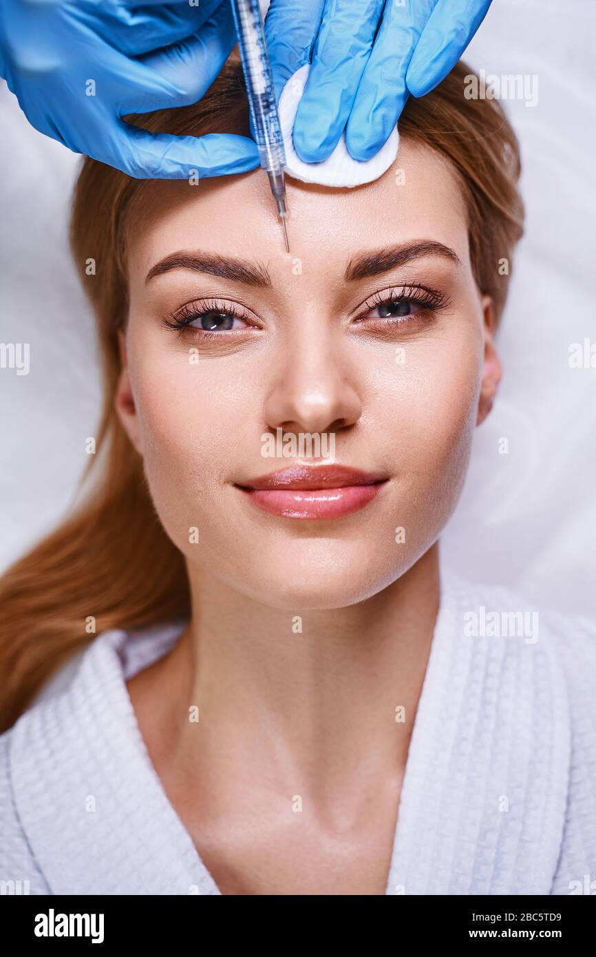 Smiling female getting botox hi-res stock photography and images - Alamy