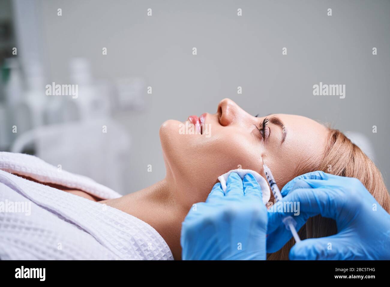 Woman receiving injections treatment hi-res stock photography and ...