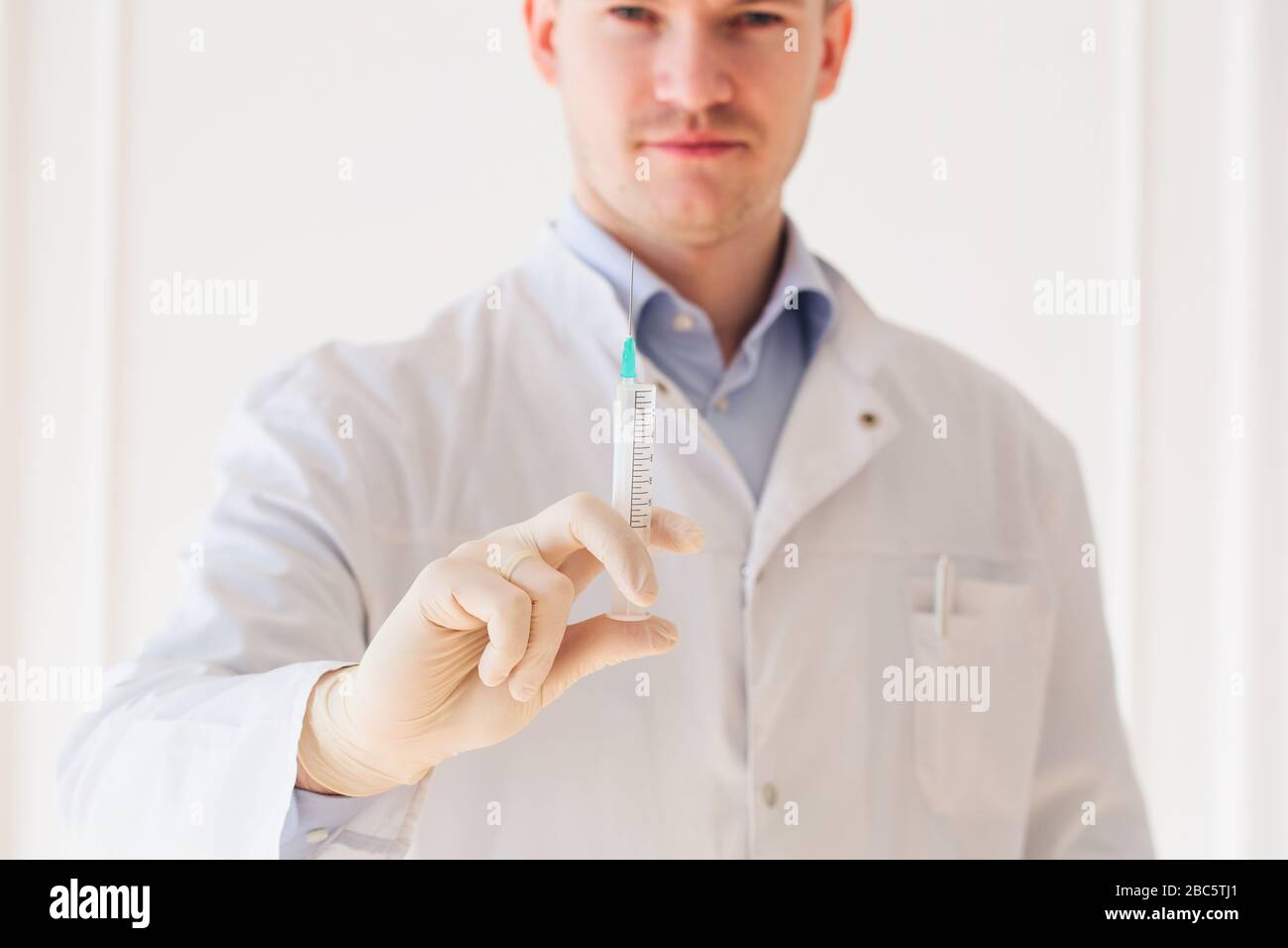 Close up of male doctor syringe with injection Stock Photo - Alamy