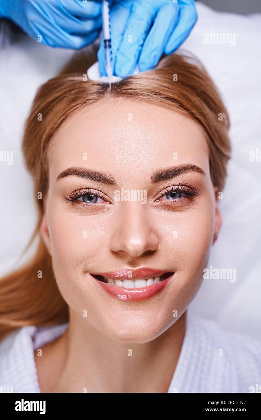 Happy female treating hair with injections stock photo Stock Photo - Alamy