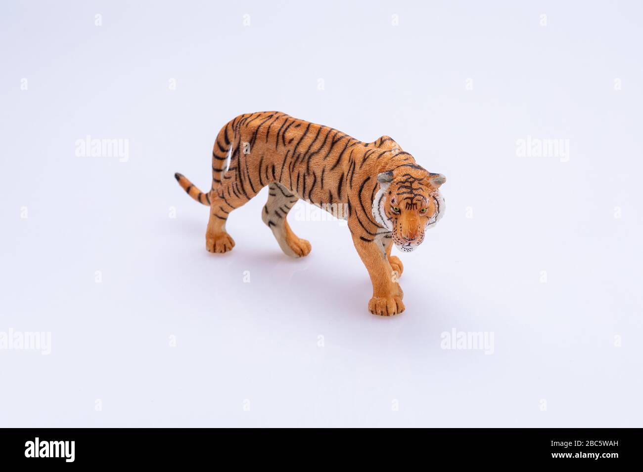 Tiger toy isolated in front a white background Stock Photo - Alamy