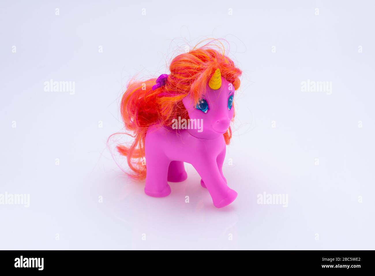 Pink unicorn toy isolated in front a white background Stock Photo - Alamy